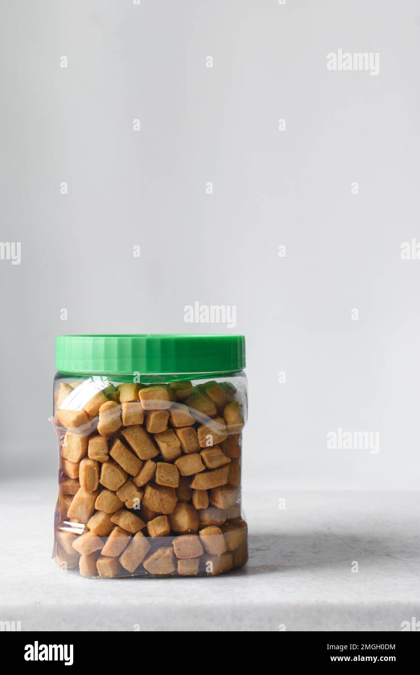 Nigerian Chin chin in a plastic jar, Fried chin-chin snack in a plastic ...