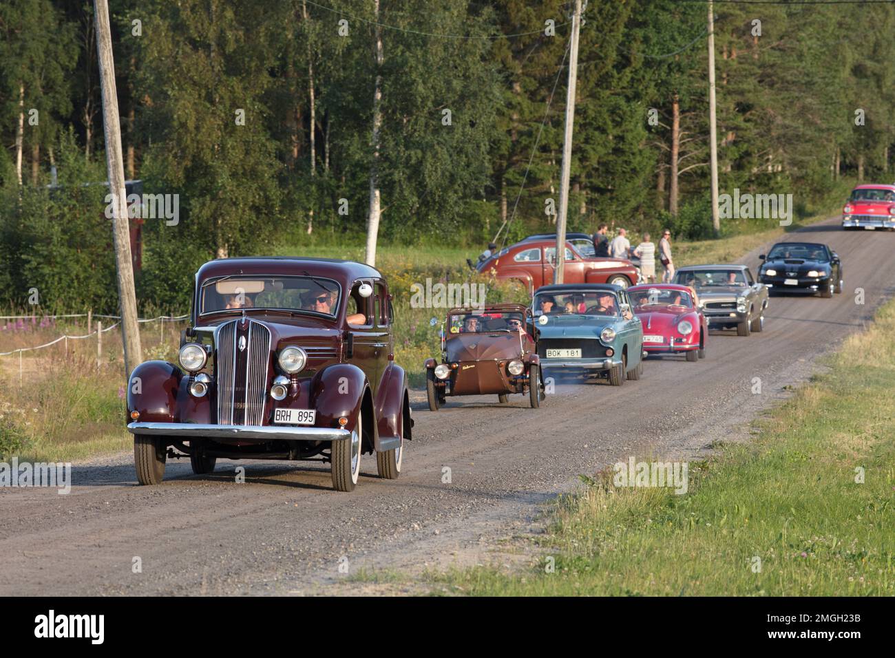 UMEÅ, SWEDEN ON JULY 14, 2021. Old classic cars cruising on a country ...