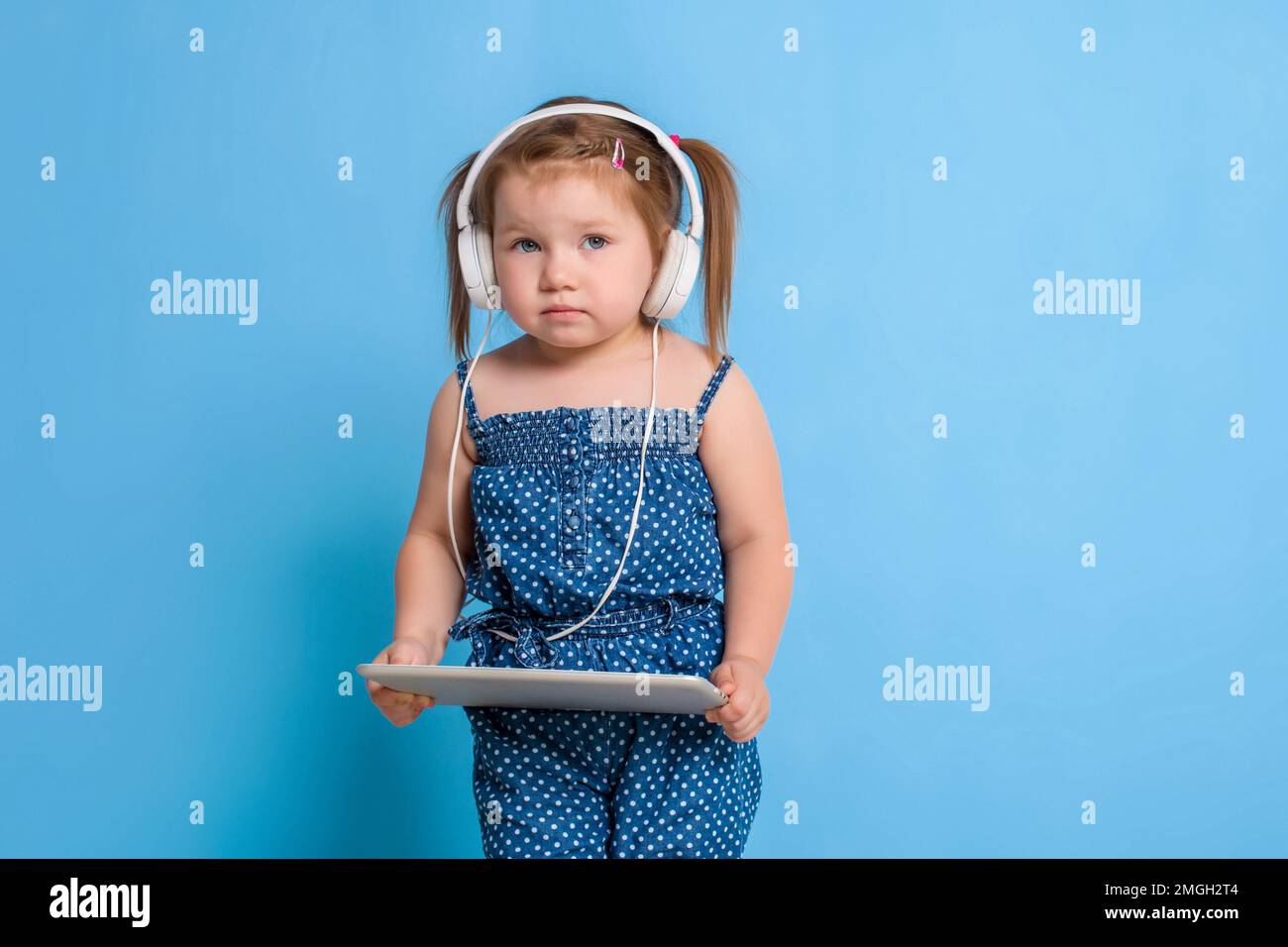 Beautiful cute happy little girl with headphones Stock Photo - Alamy