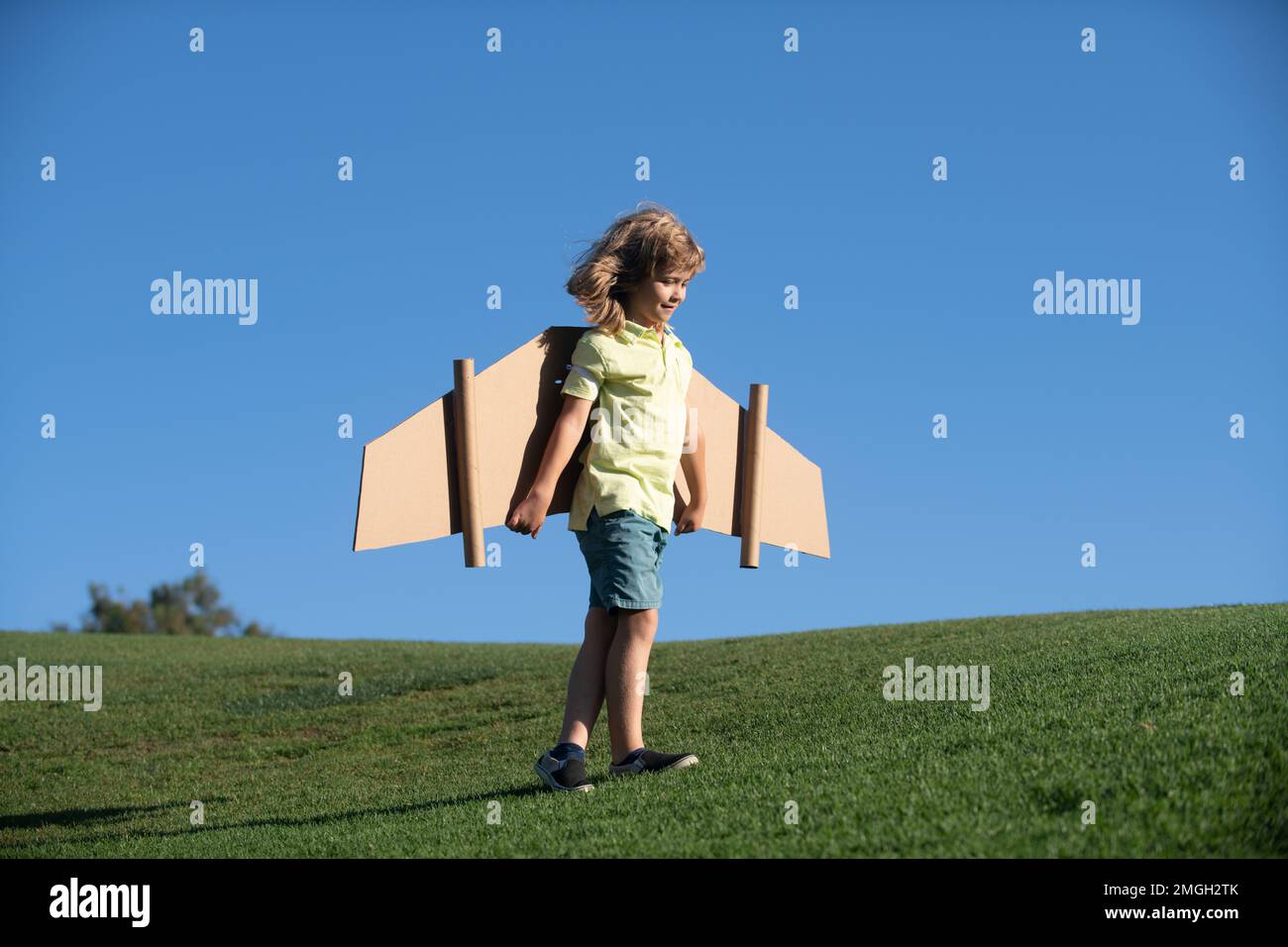 Child to be pilot. Kid with paper wings flying. Summer vacation and ...
