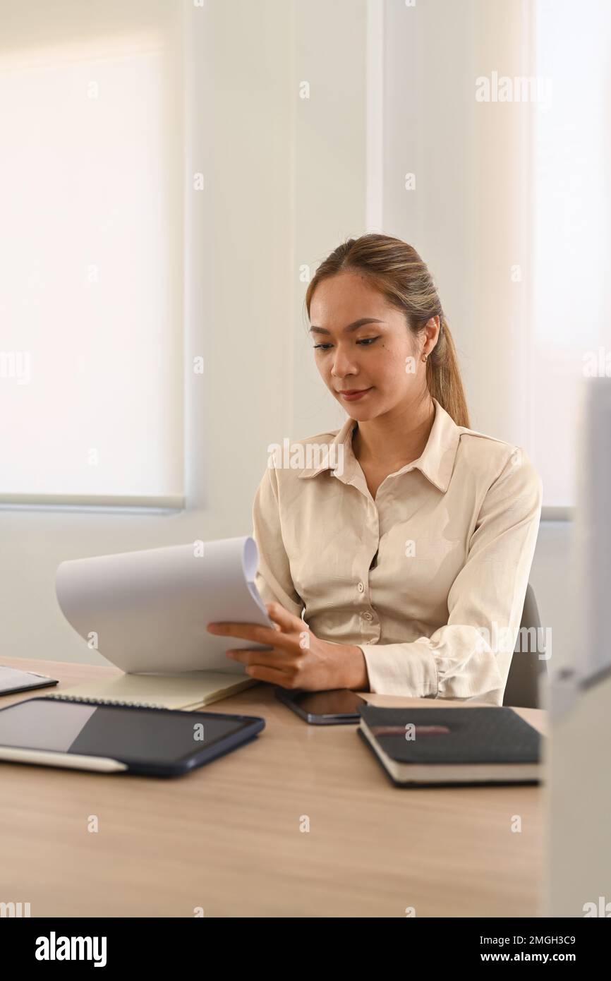 Gorgeous businesswoman preparing report, analyzing work results at her ...
