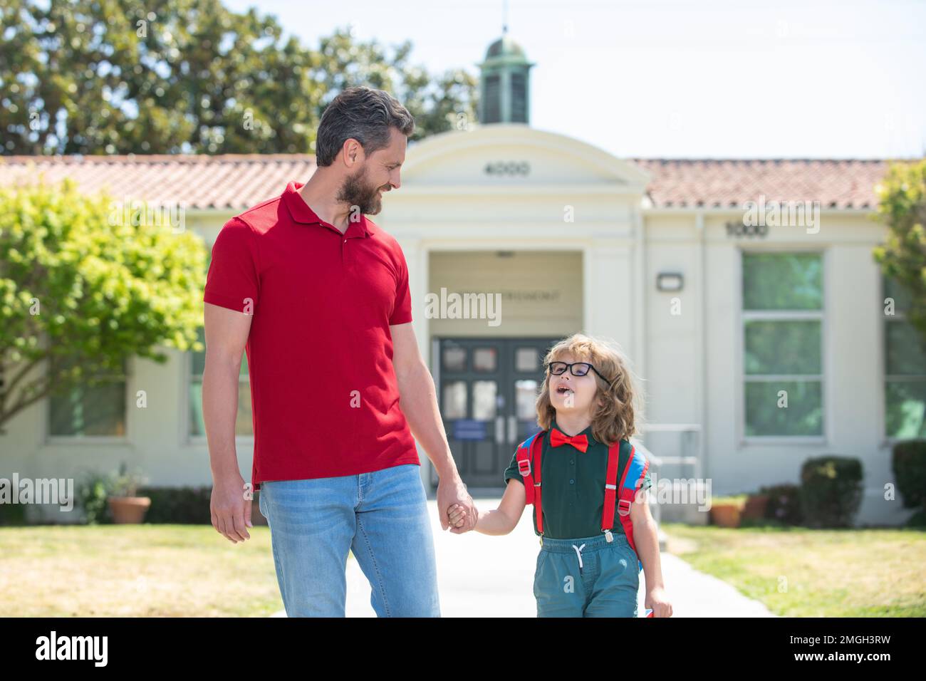Father and son run with father after come back from school. Kids ...