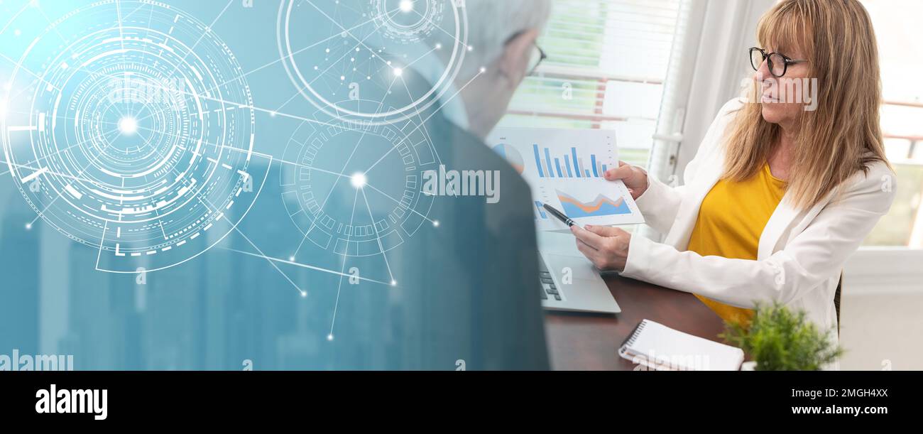 Two mature business people working together in office; panoramic banner ...