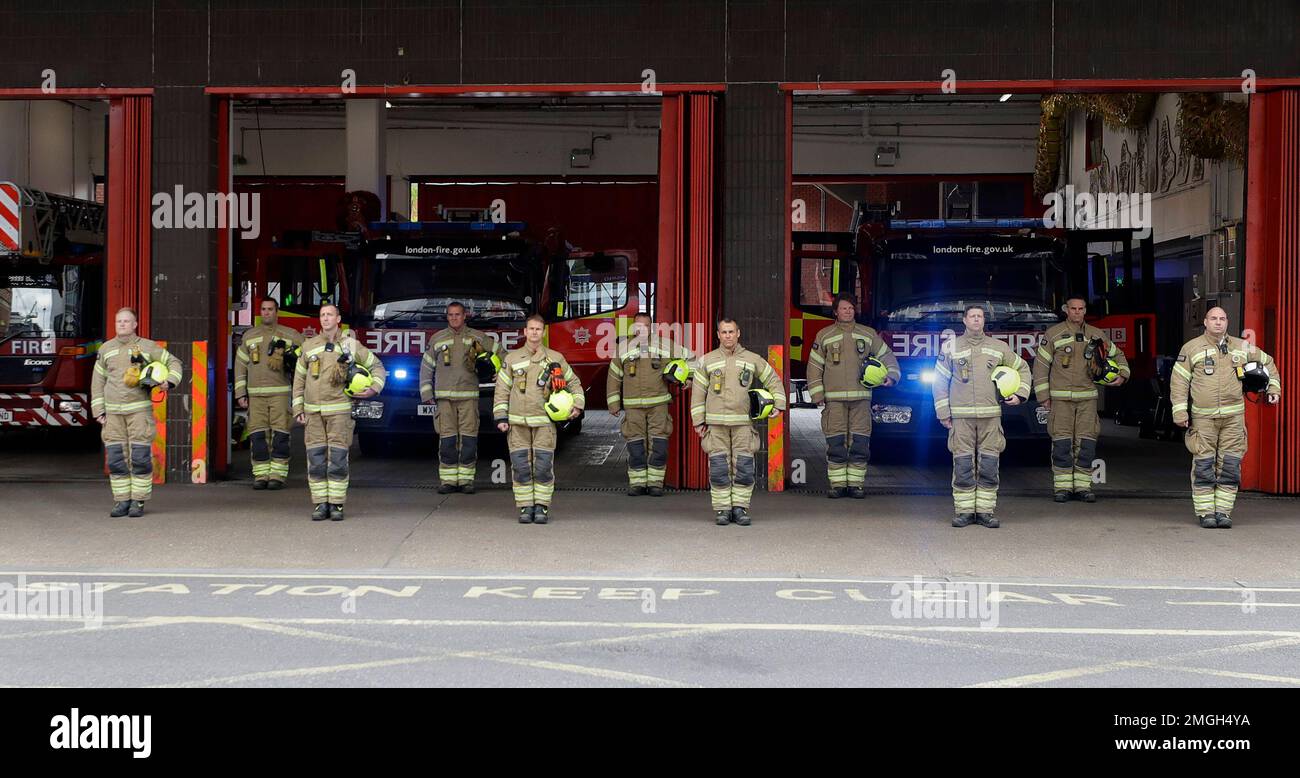 Firefighters social distance as they stand for a minutes silence ...