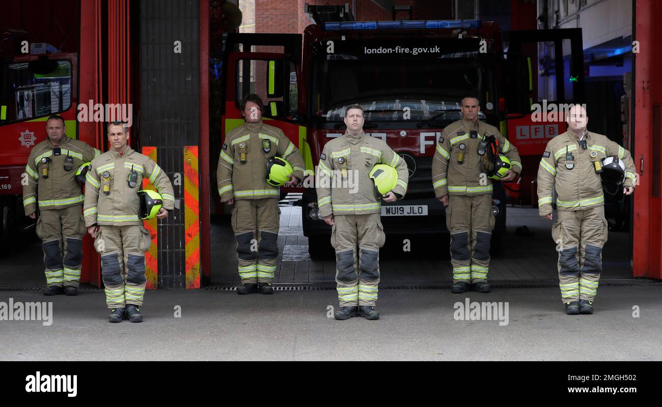 Firefighters social distance as they stand for a minutes silence ...