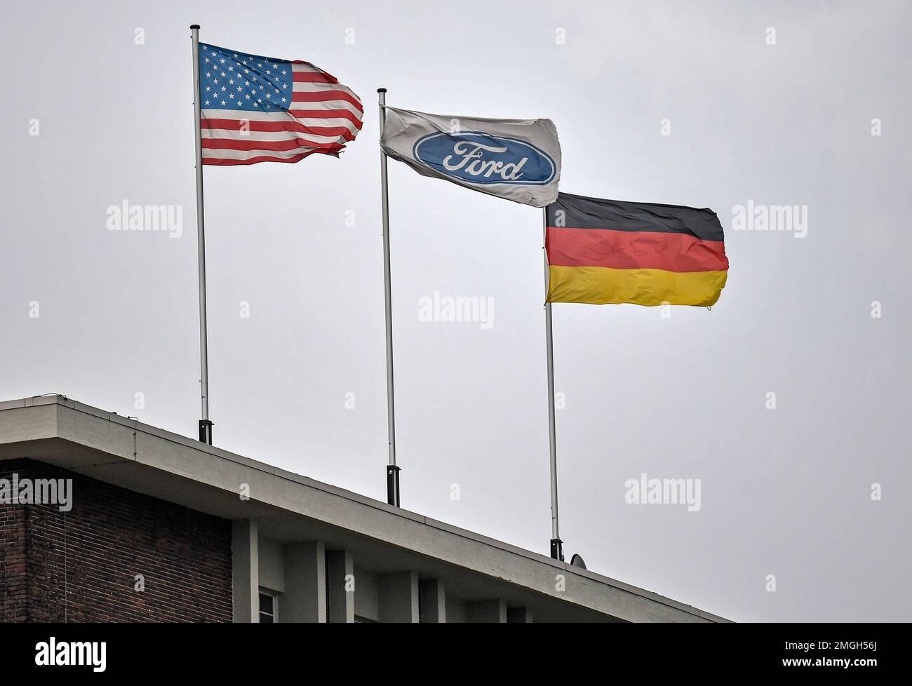 A US a Ford and a German flag wave at the headquarters at the Ford car ...