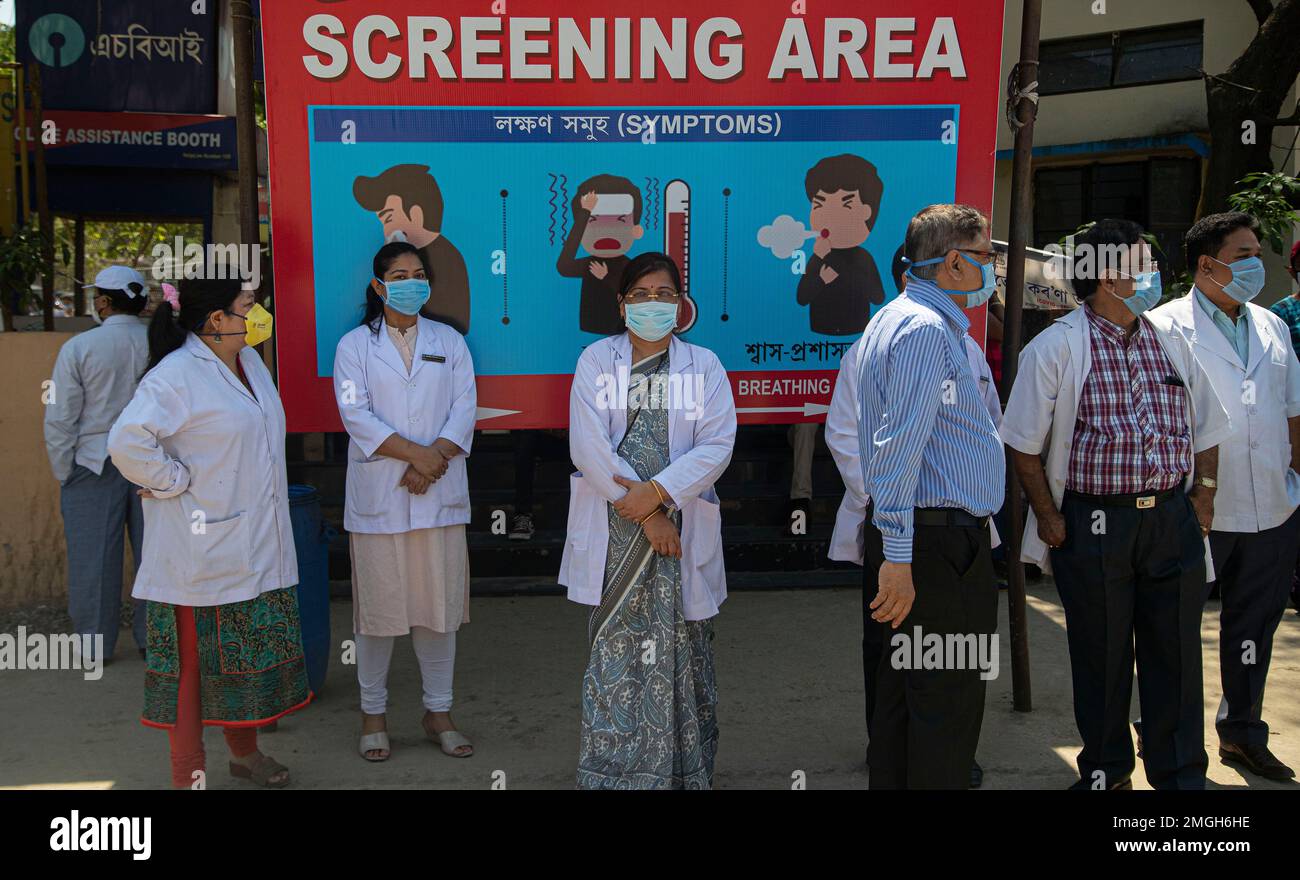 Indian health workers of Guwahati Medical College Hospital, (GMCH) wait ...