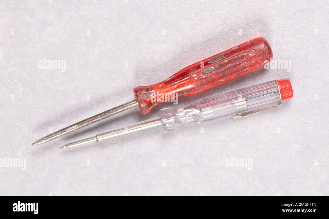 Old tool (awl) isolated on a grey background Stock Photo - Alamy