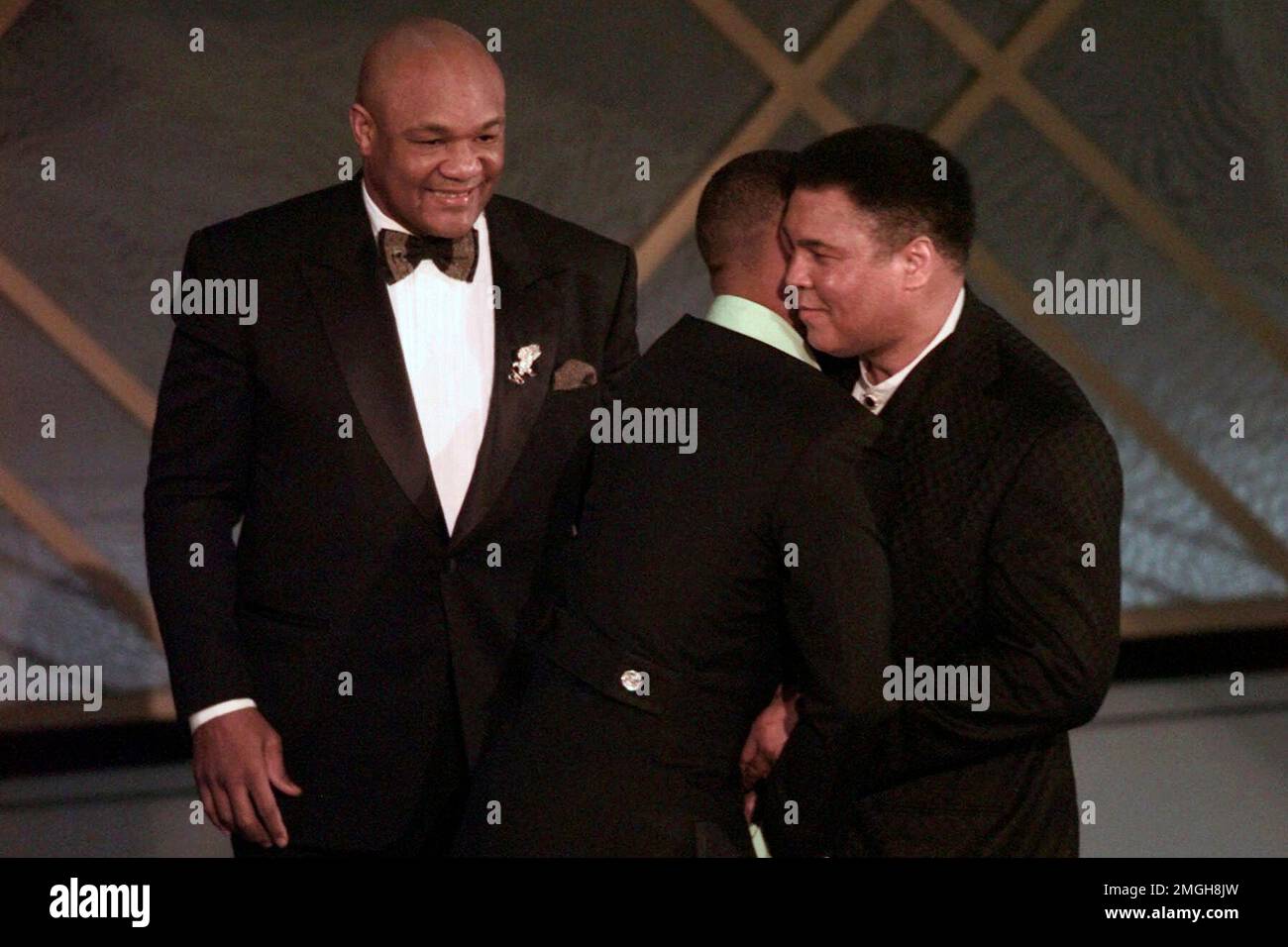 FILE - In this March 24, 1997, file photo, George Foreman, left, looks ...