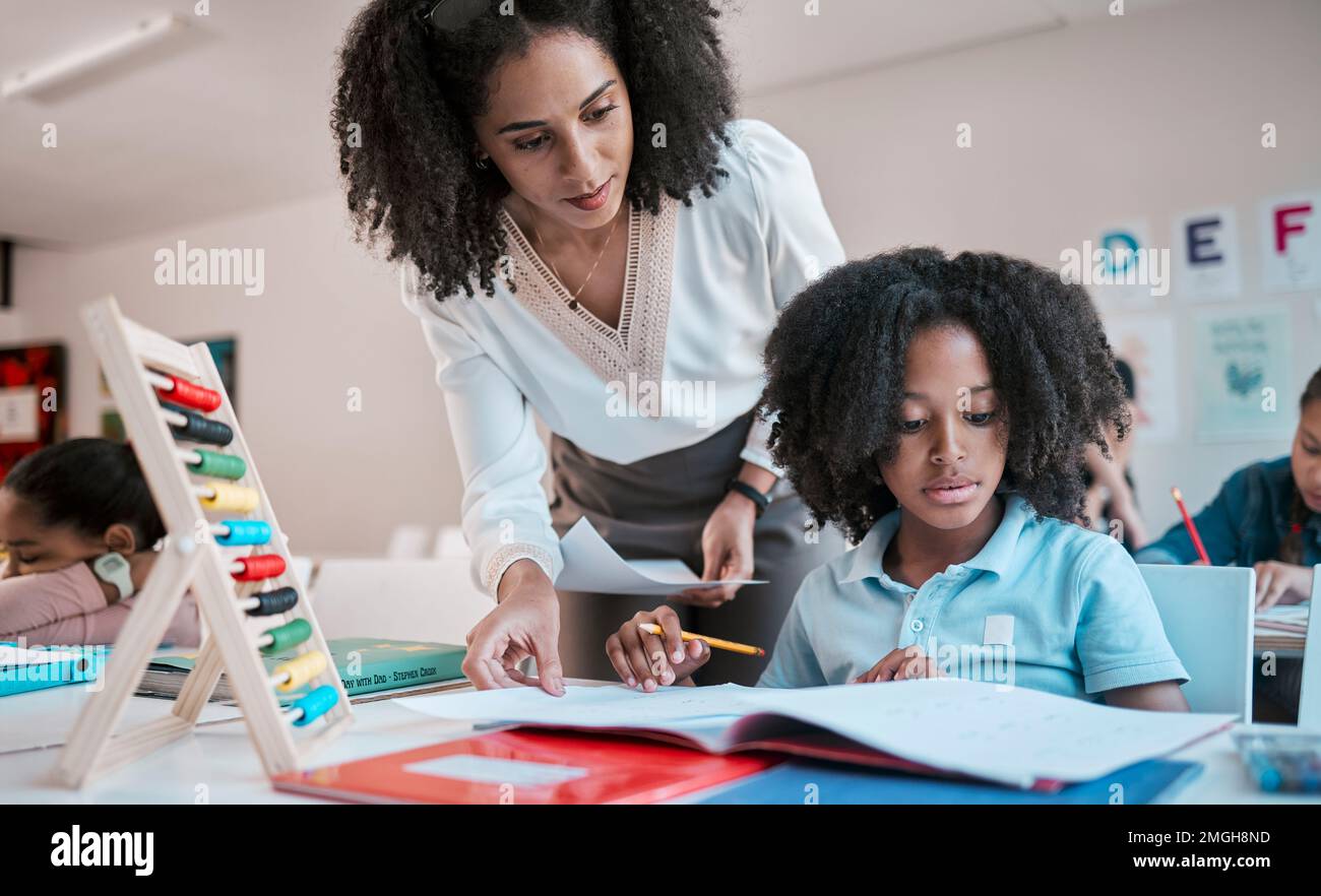 Math, education or teacher helping a child in a classroom with learning ...