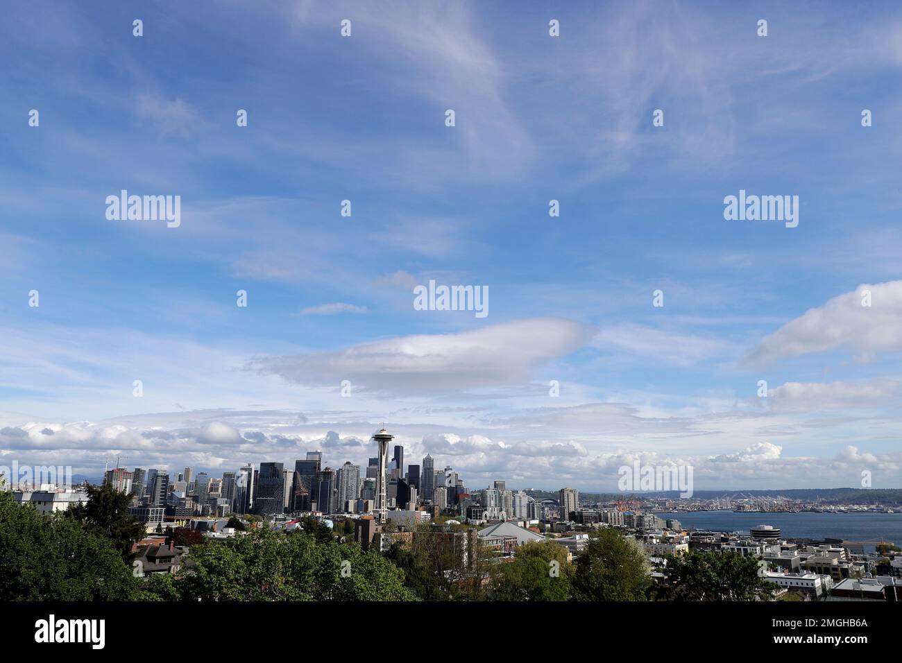 The Space Needle and the Seattle skyline are shown against a blue sky ...