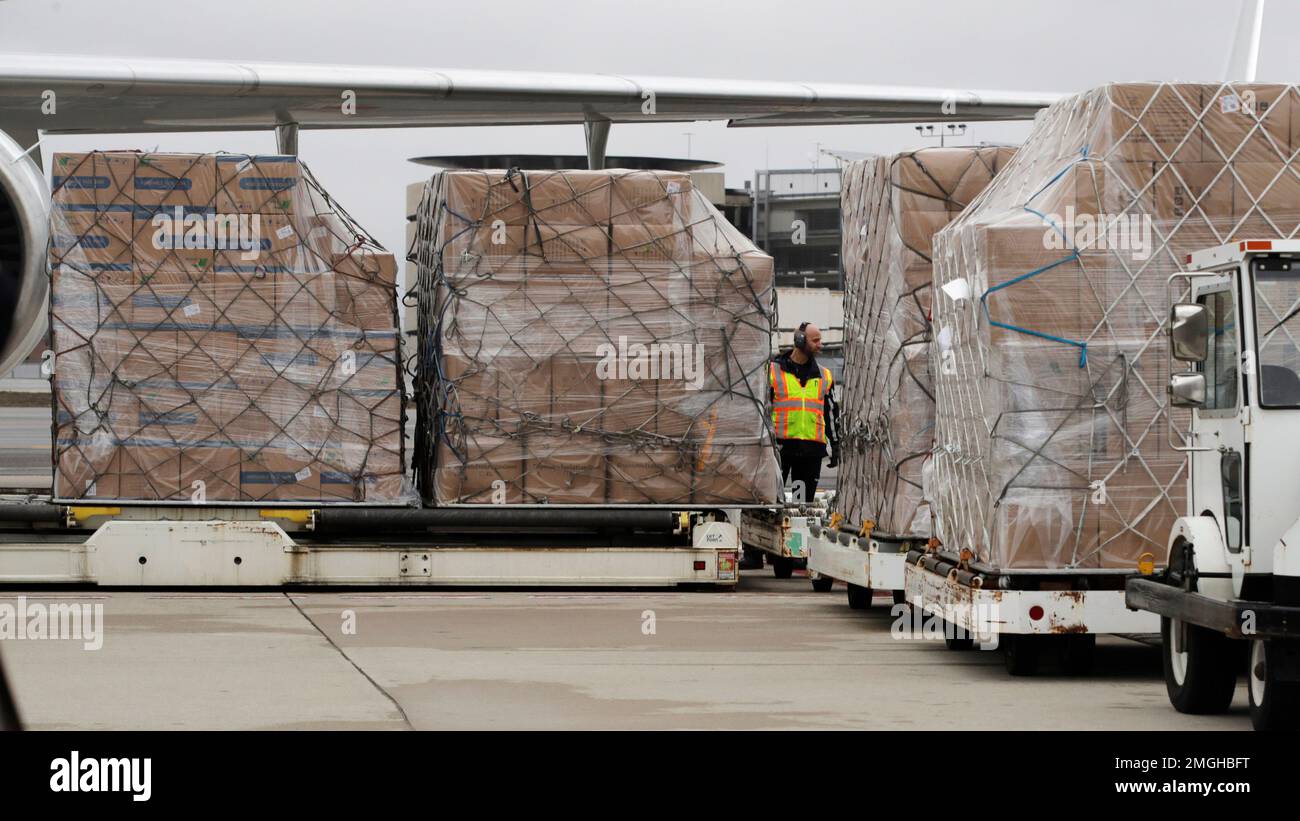 A ground crew worker looks on as over 110,000 pounds of personal ...