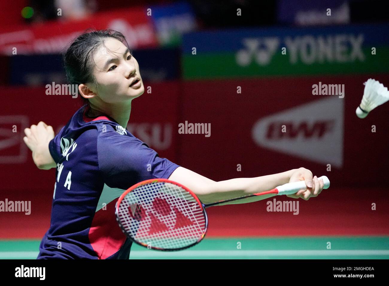 China's Han Yue return a shoot to India's Saina Nehwal during the women ...