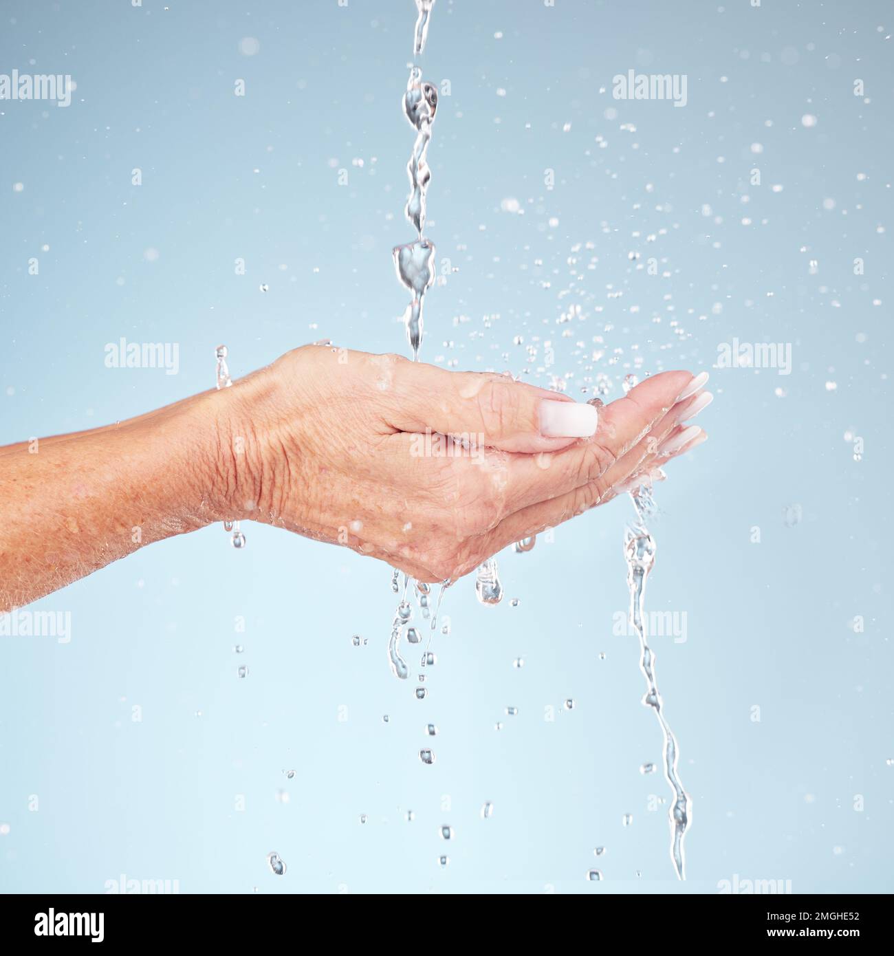 Senior hands, water splash for clean hygiene, fresh sustainability or ...