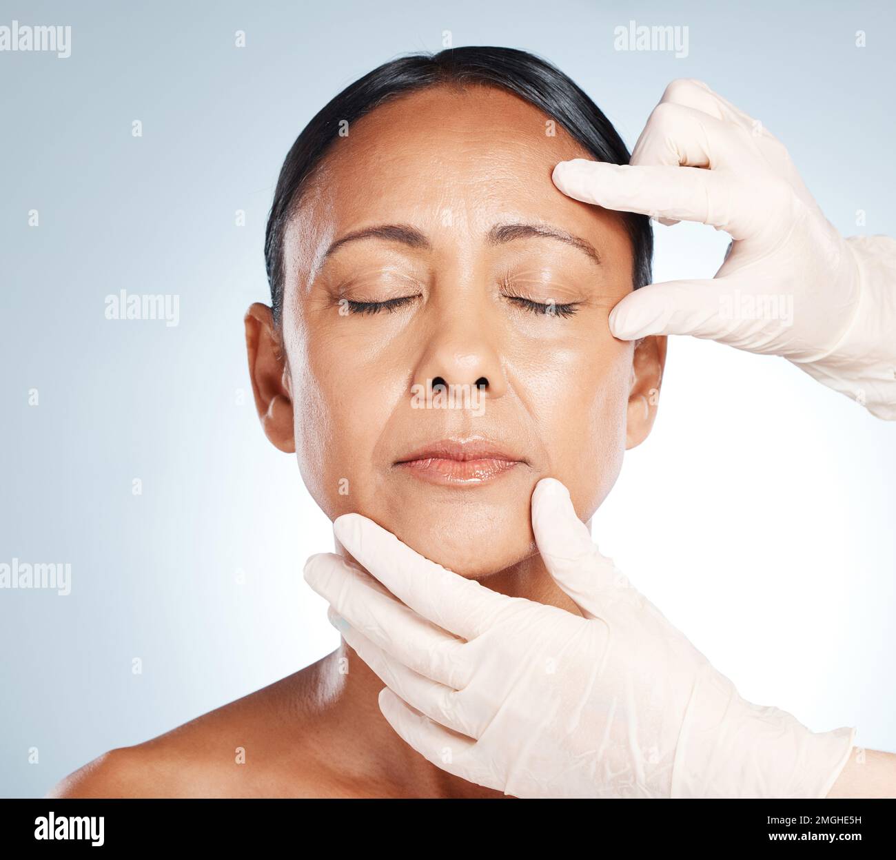 Botox, mature woman and doctor hands check face for plastic surgery and ...