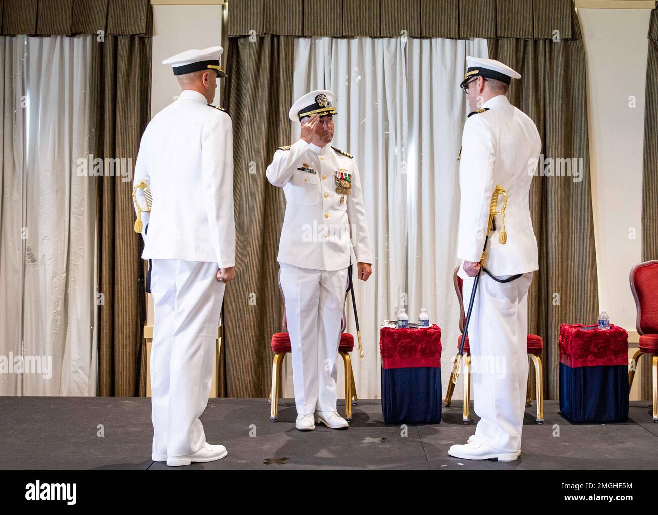 Capt. Brian Hogan, commodore, Submarine Squadron Eight, center, renders ...