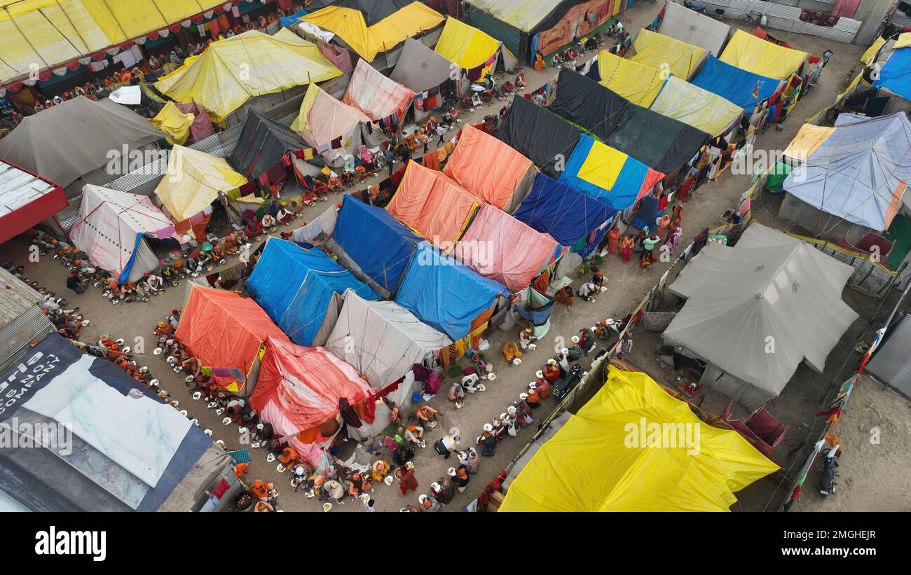 Hindu devotees participate in a community feast at the Sangam, the ...