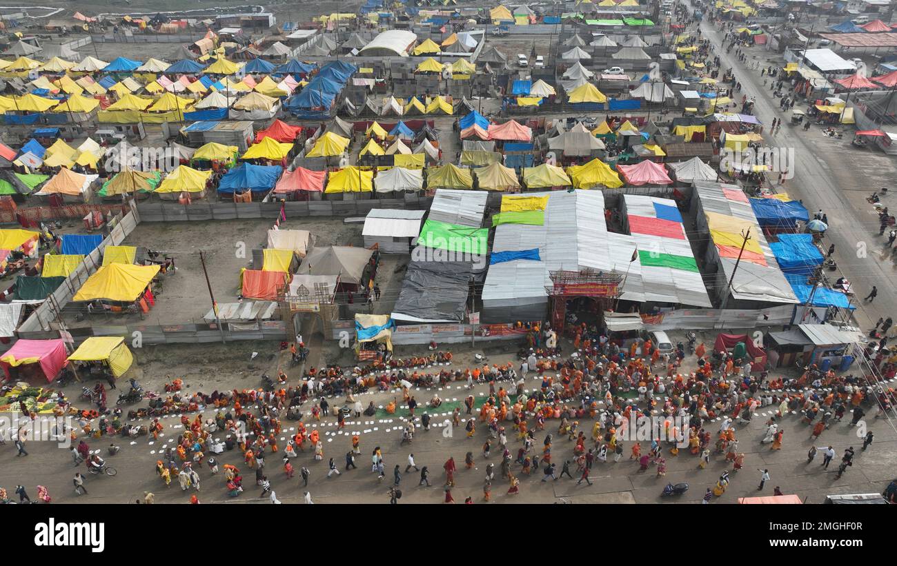 Hindu devotees participate in a community feast at the Sangam, the ...