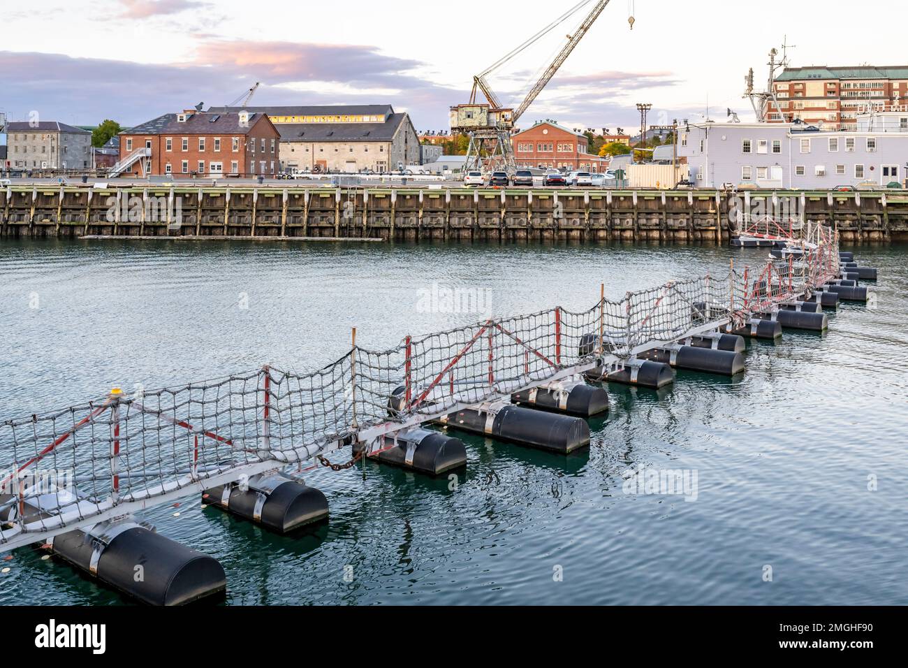Cityscape of the floating mesh barrier on pontoons in the bay with a ...