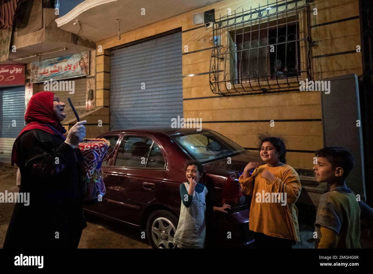 Hajja Dalal, a 46-year-old "mesaharati," or dawn caller, wakes people up for a meal before ...