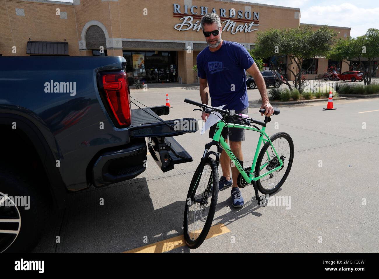 Rob Larson prepares to place his newly purchased bicycle in the back of ...