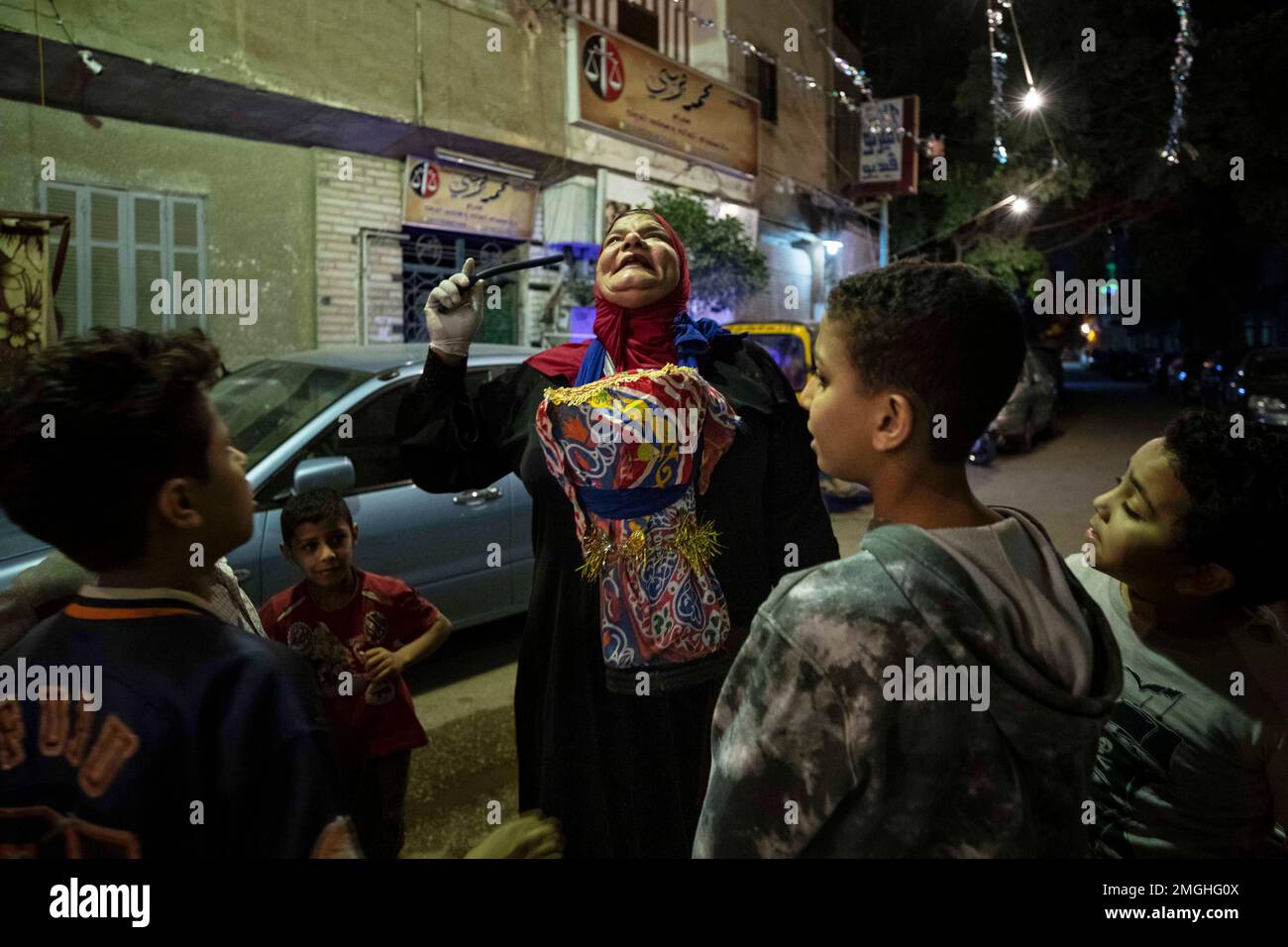 Hajja Dalal, a 46-year-old "mesaharati," or dawn caller, wakes people up for a meal before ...