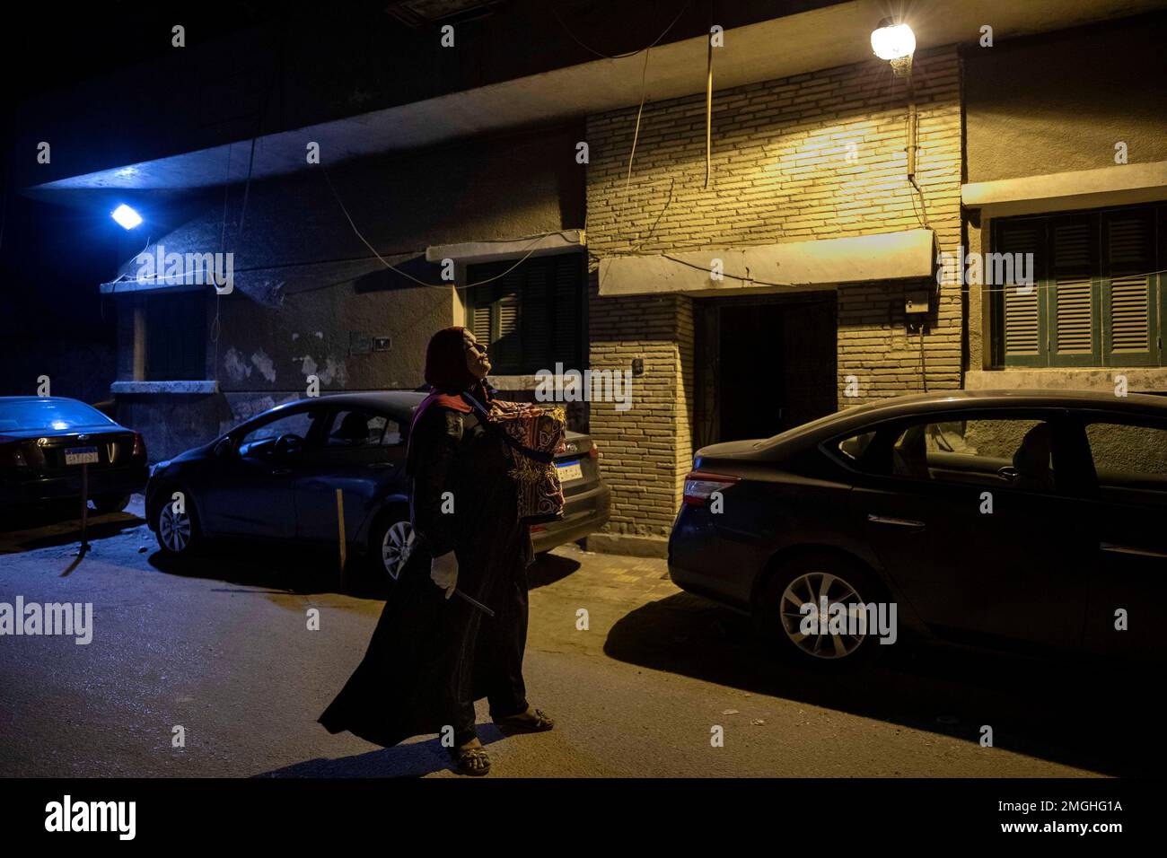 Hajja Dalal, a 46-year-old "mesaharati," or dawn caller, wakes people up for a meal before ...