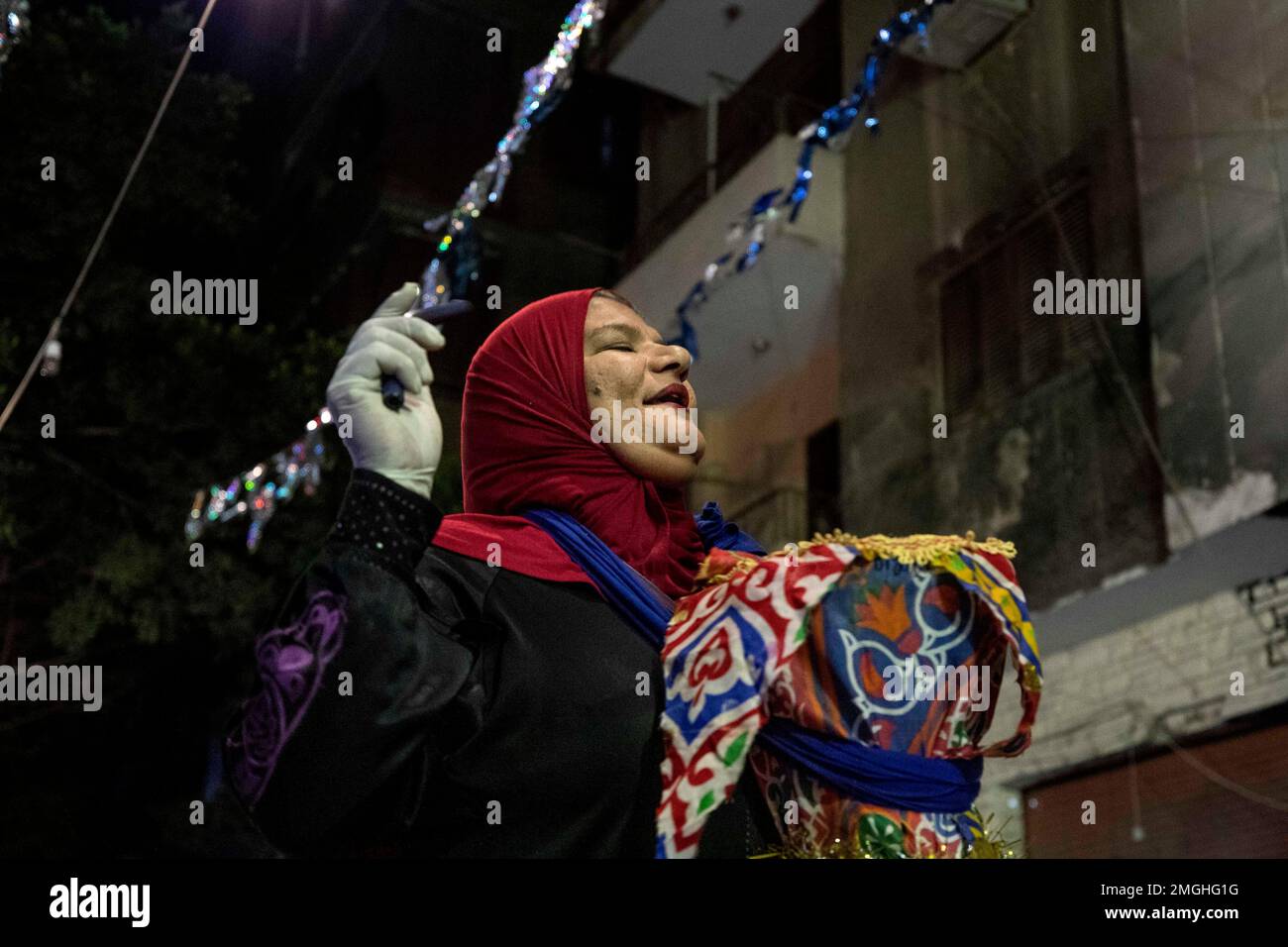 Hajja Dalal, a 46-year-old "mesaharati," or dawn caller, wakes people up for a meal before ...