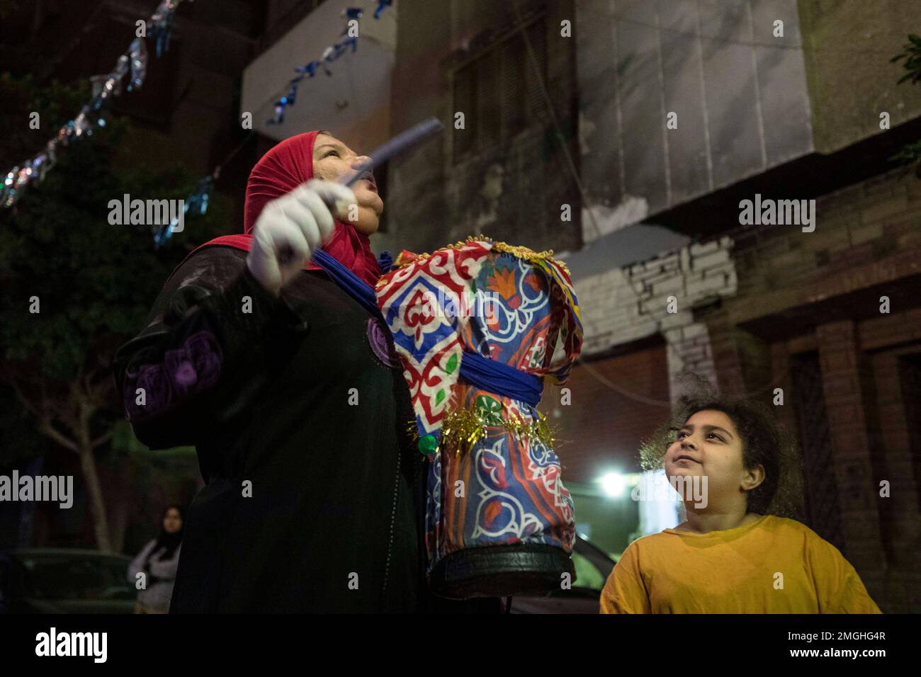 Hajja Dalal, a 46-year-old "mesaharati," or dawn caller, wakes people up for a meal before ...