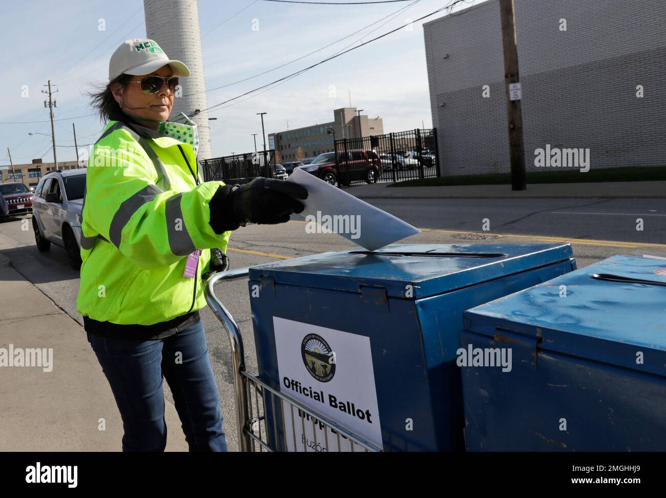 Board of elections worker Sheila McNea drops a ballot into the ballot ...