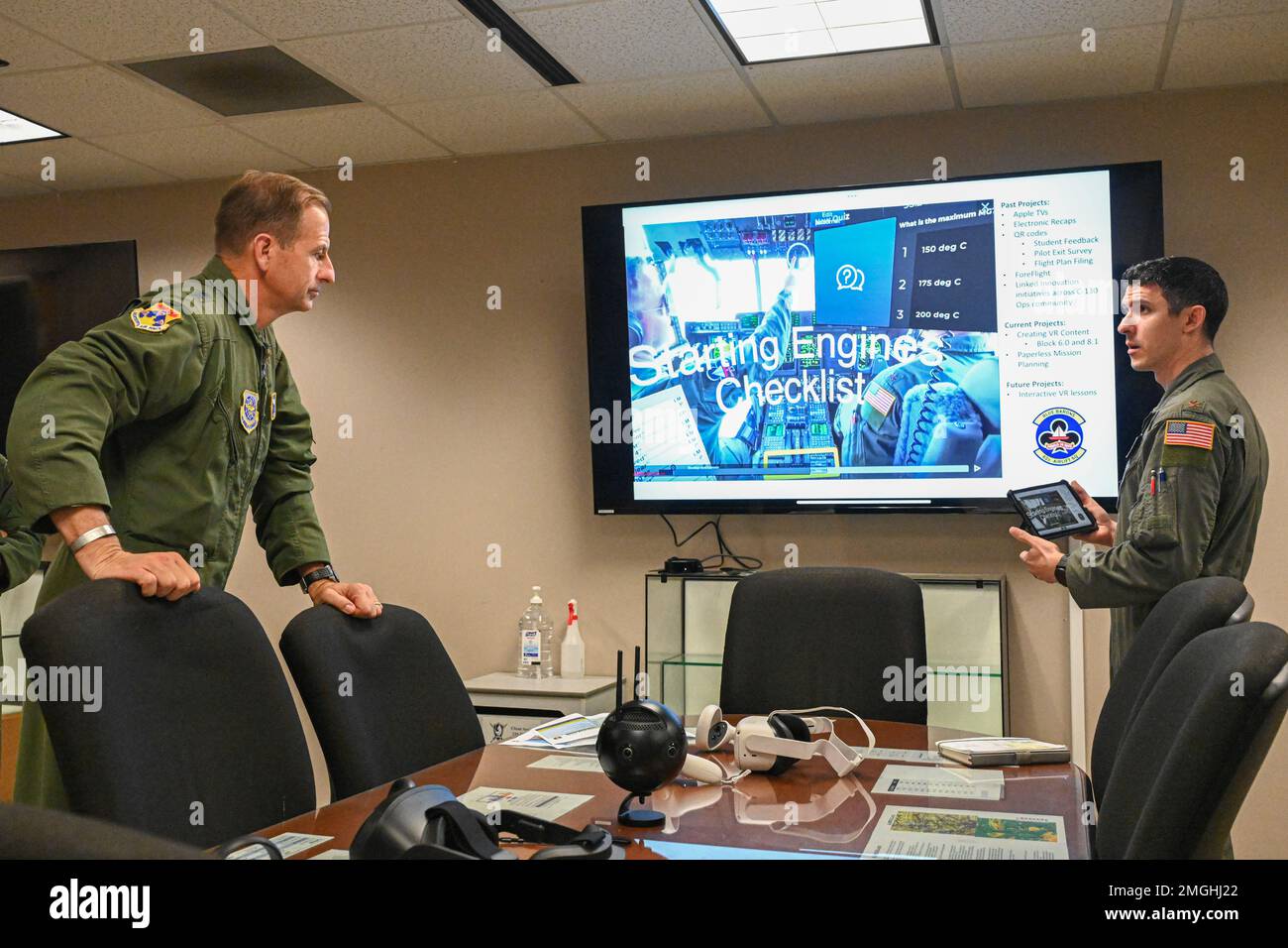 Maj. Gen. Corey Martin, 18th Air Force commander, is briefed by a 62nd ...