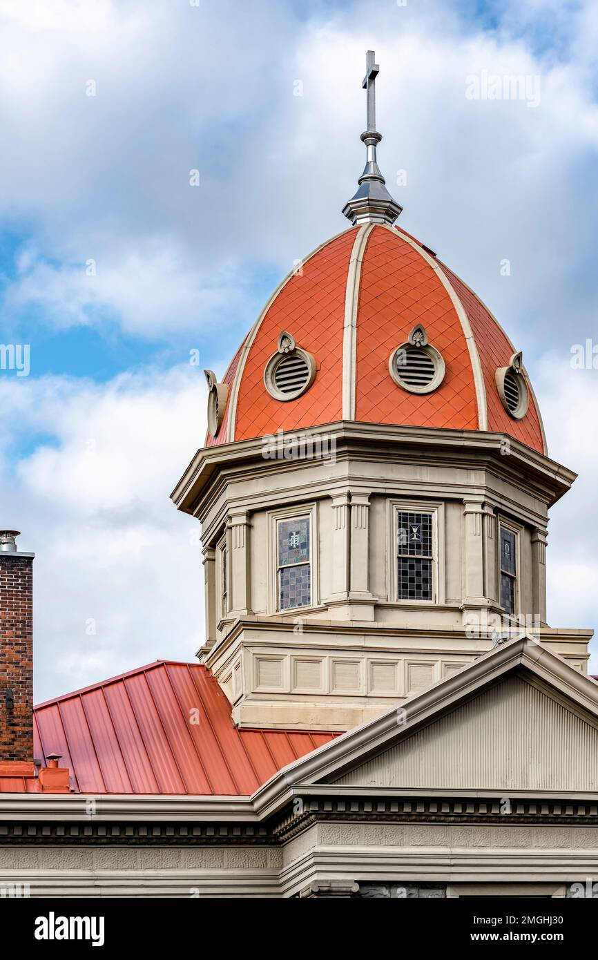 The dome of a small local Christian church covered with red metal tiles ...