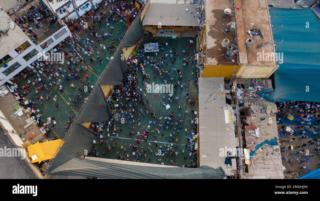 Inmates gather around two corpses of inmates killed during a prison ...