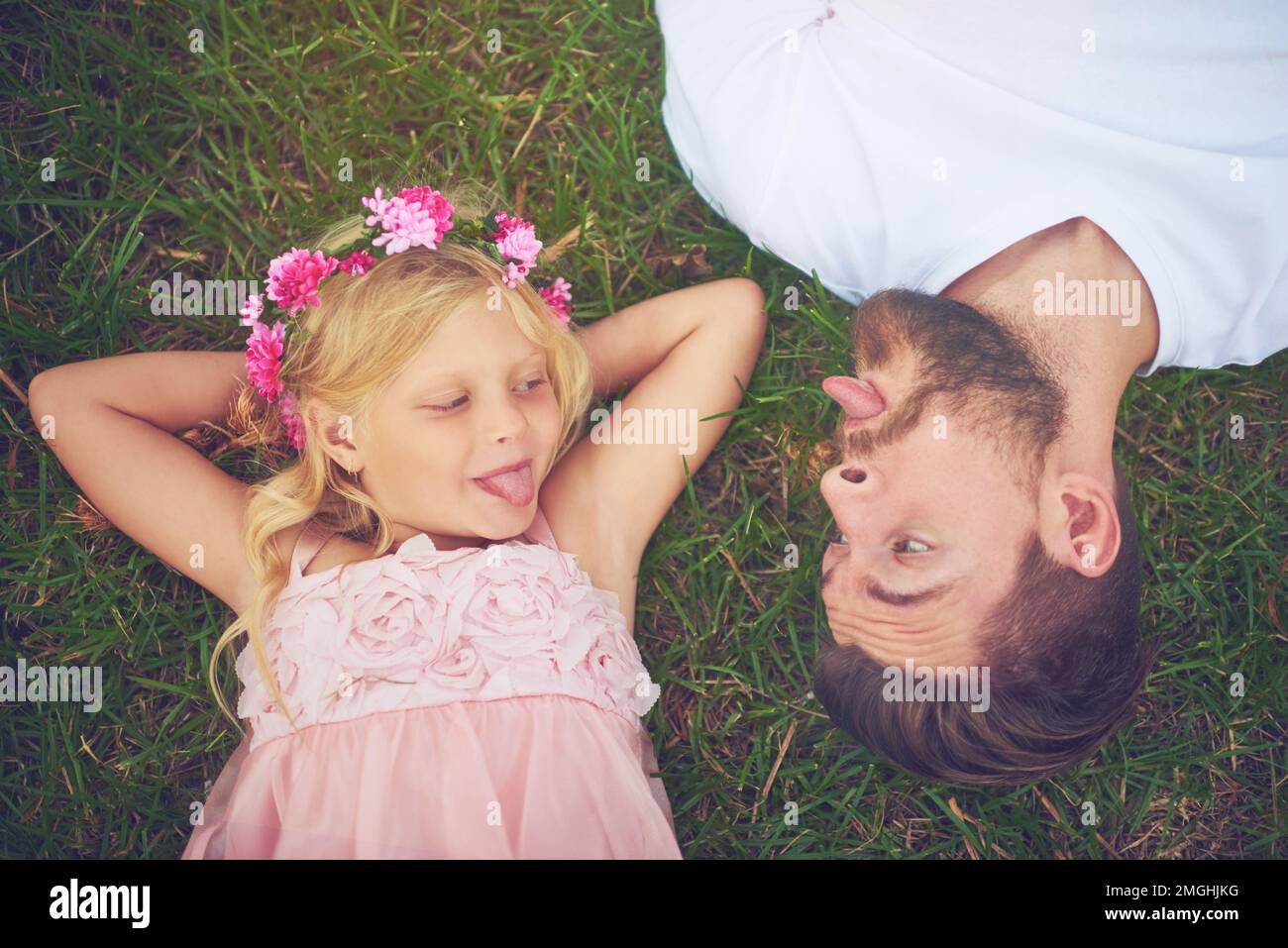 I make better faces than you daddy. a happy daughter and father lying ...