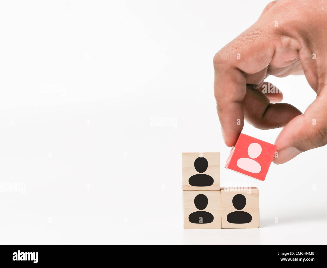 Man pick and take red wooden cube with human symbol. Recruitment and ...