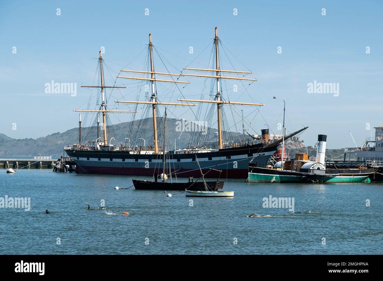 People swim at Aquatic Park with the historic Balclutha square-rigged ...