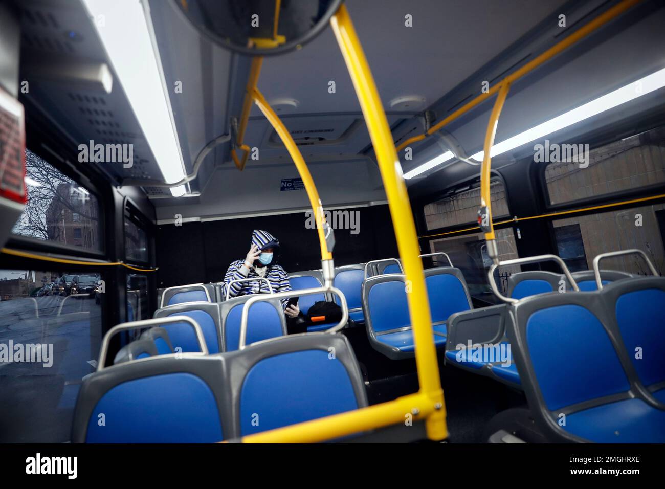 A customer wears personal protective equipment while riding the MTA bus ...