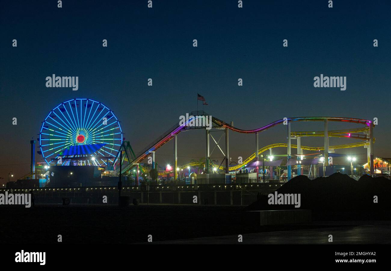 Pacific Park's solar-powered Ferris wheel lights show a green "Earth ...