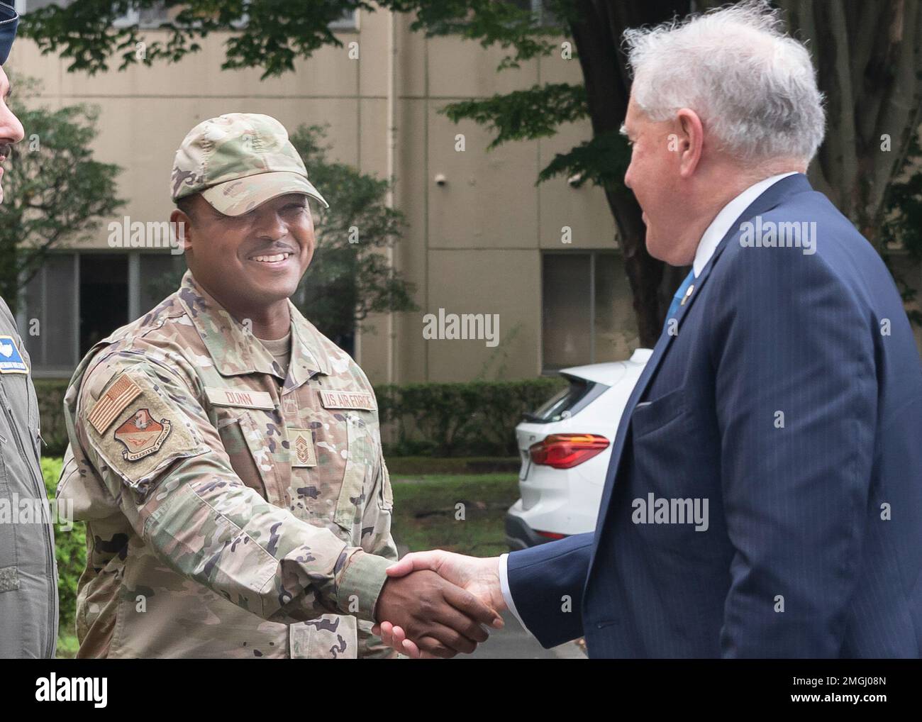 Chief Master Sgt. Jerry Dunn, 374th Airlift Wing command chief, left ...