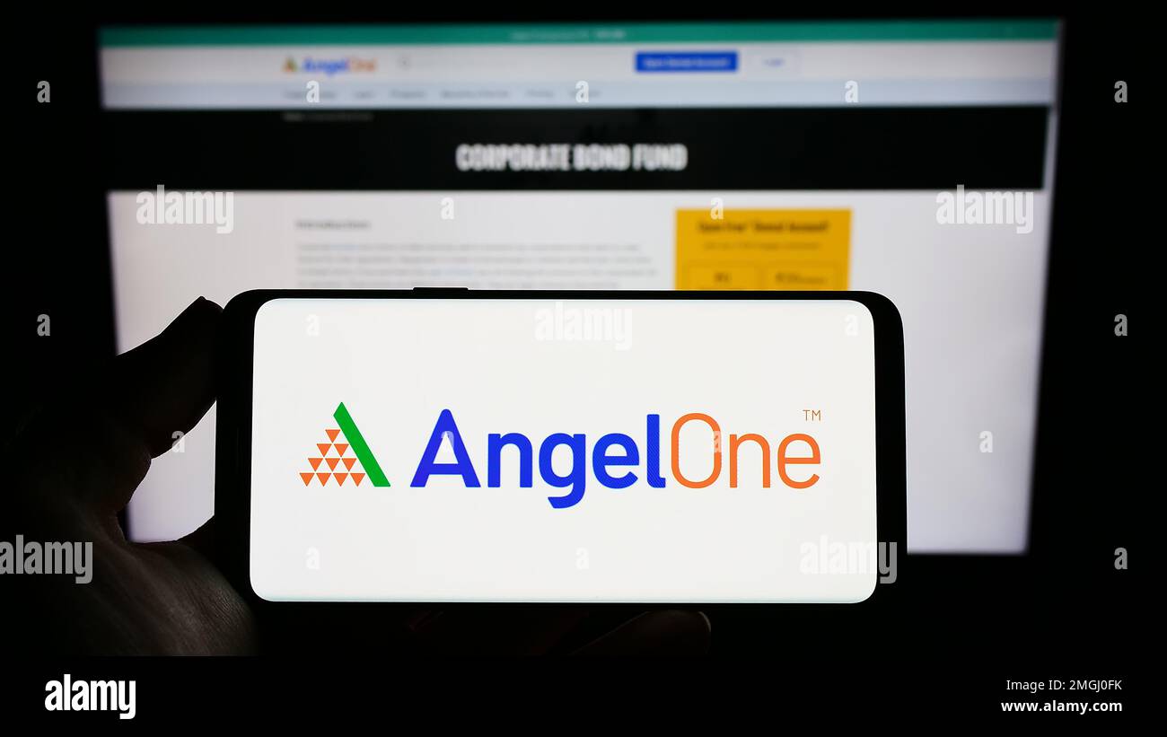Person holding smartphone with logo of Indian brokerage company Angel ...