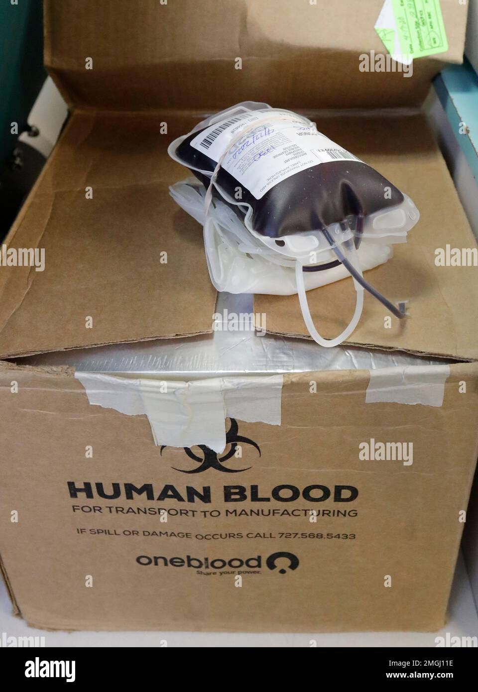 A bag of newly donated blood sits on top of a storage box aboard a ...