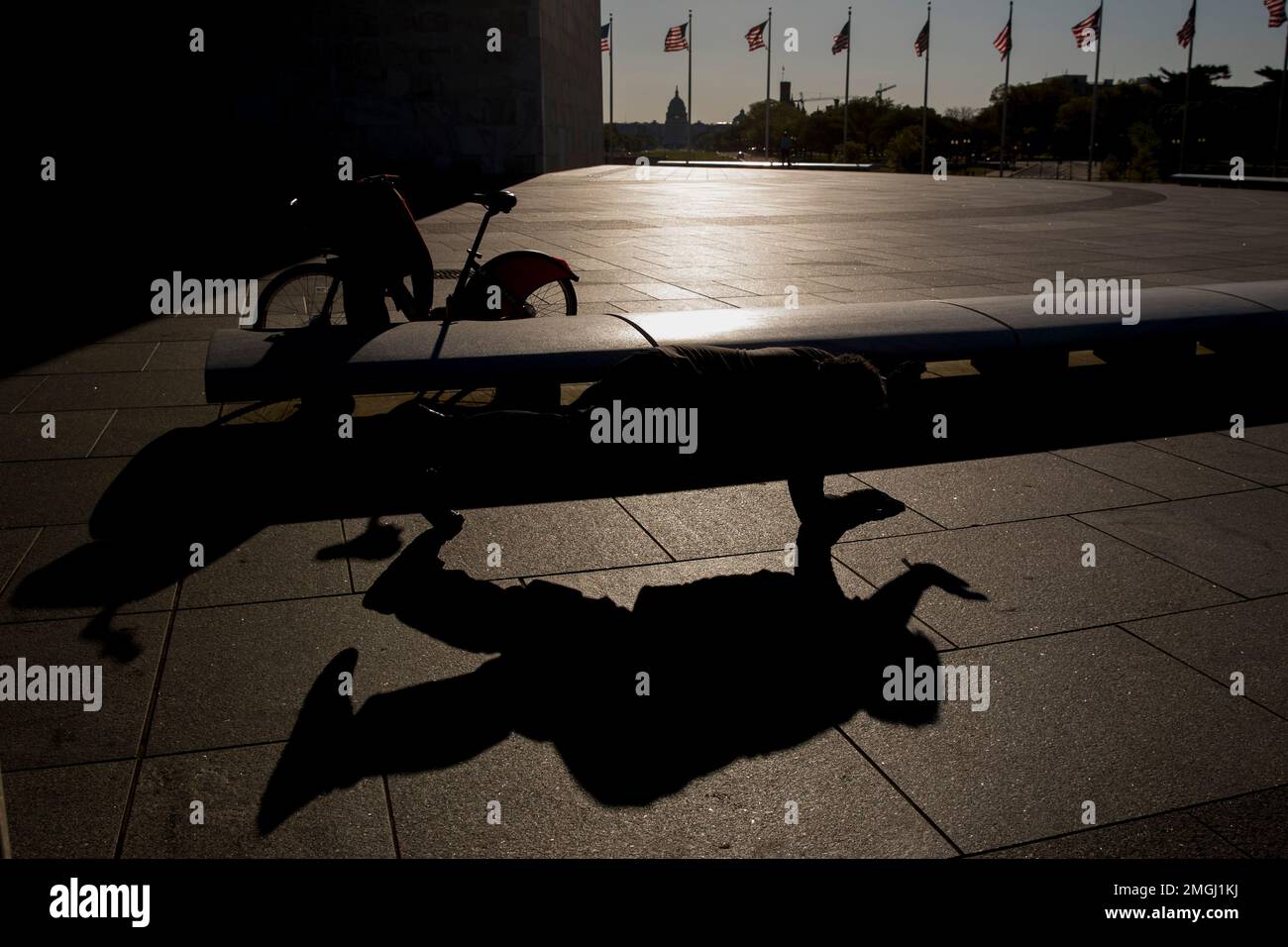 Dome of the U.S. Capitol is visible as Sean Marrett of Washington works ...