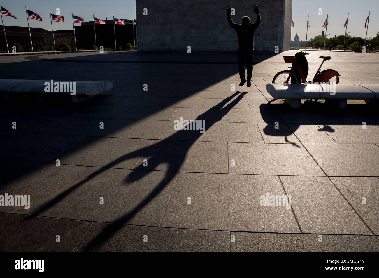Dome of the U.S. Capitol is visible as Sean Marrett of Washington works ...
