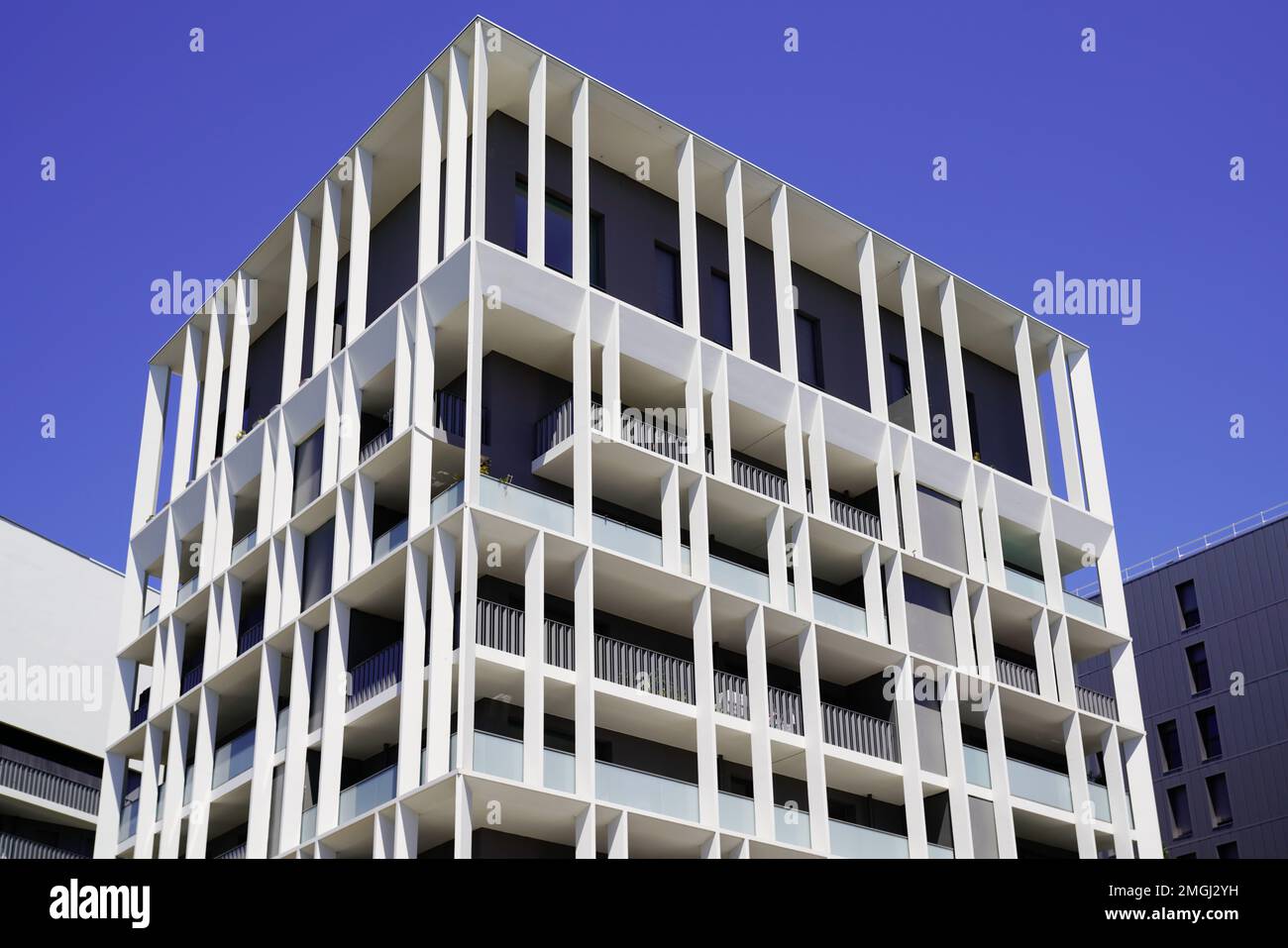Residential white square modern facade Building on blue sky background ...