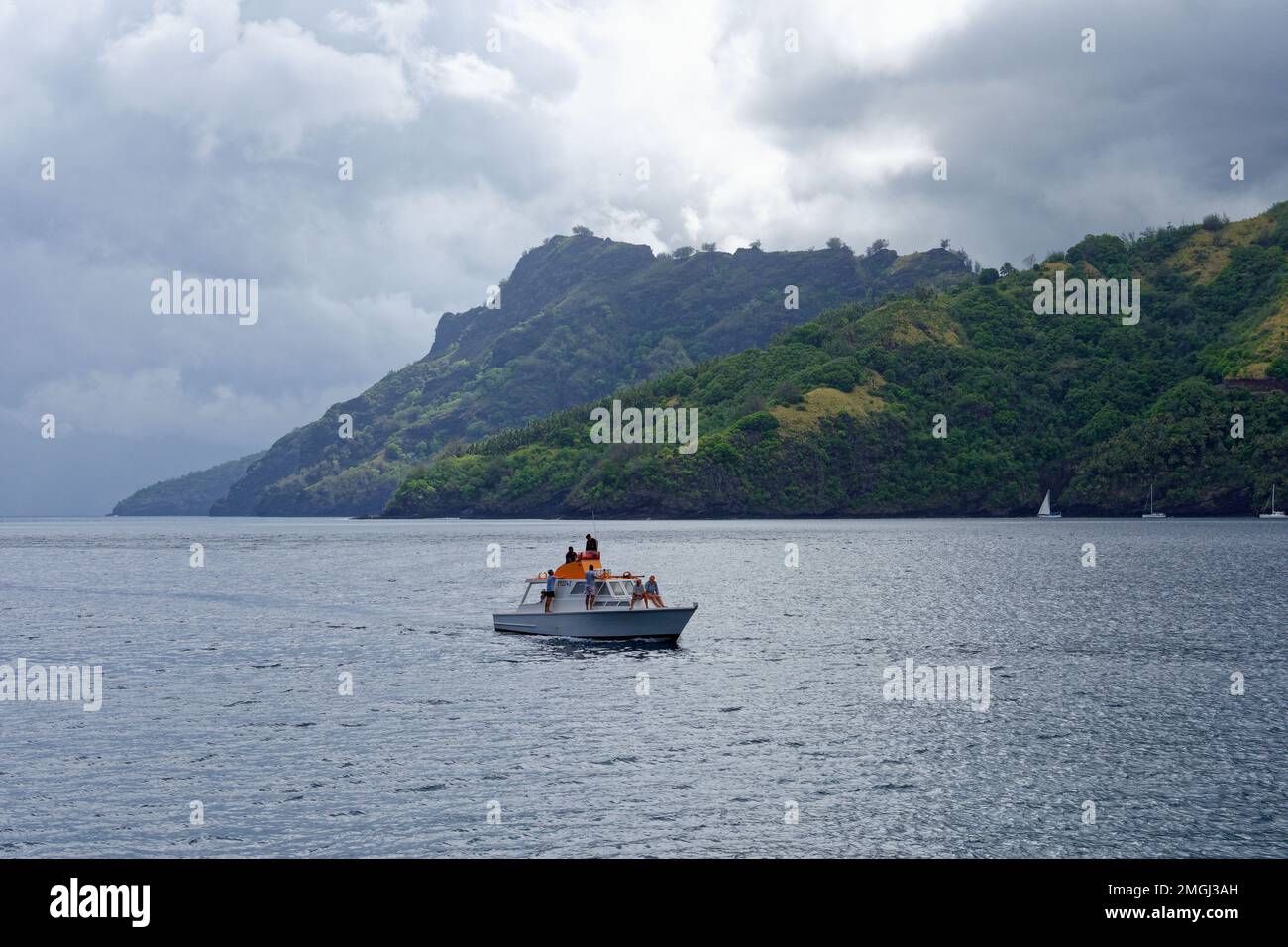 French Polynesia, Tahuata Island: boat in the Bay of Hapatoni under a ...
