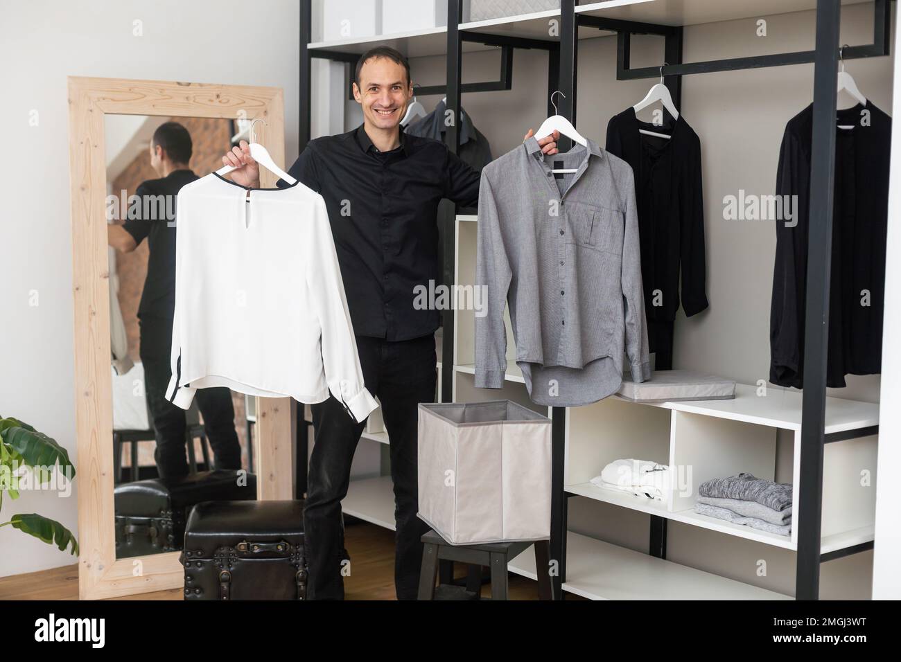 Young man organizing the closet Stock Photo - Alamy