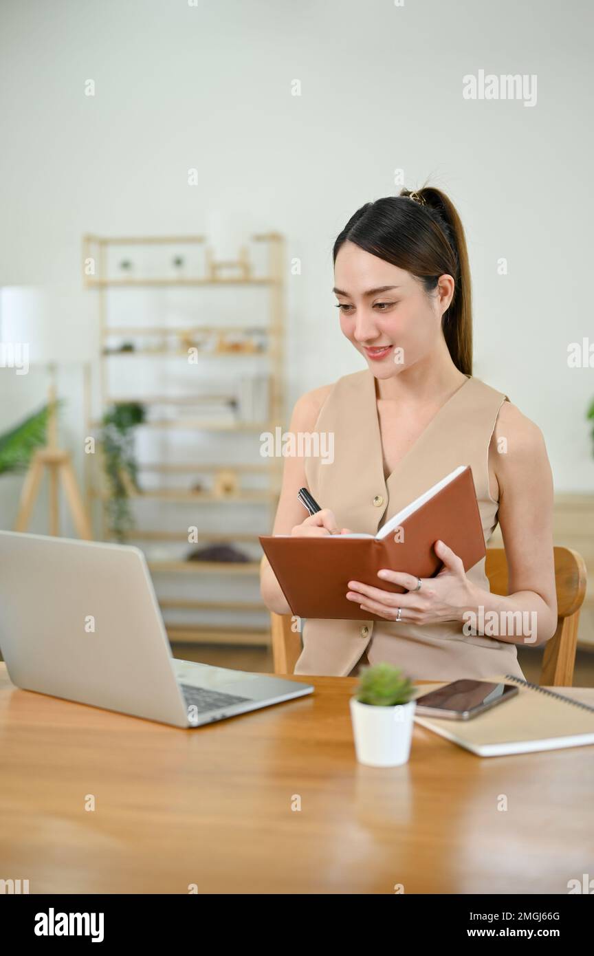 Gorgeous millennial Asian businesswoman or female assistant taking ...