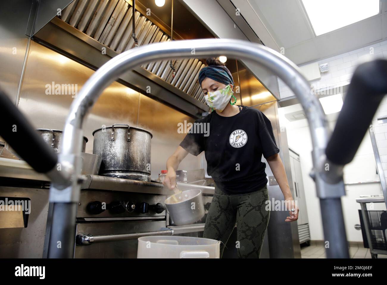 Daisy Serrano prepares soup to be delivered to homeless people amid the ...