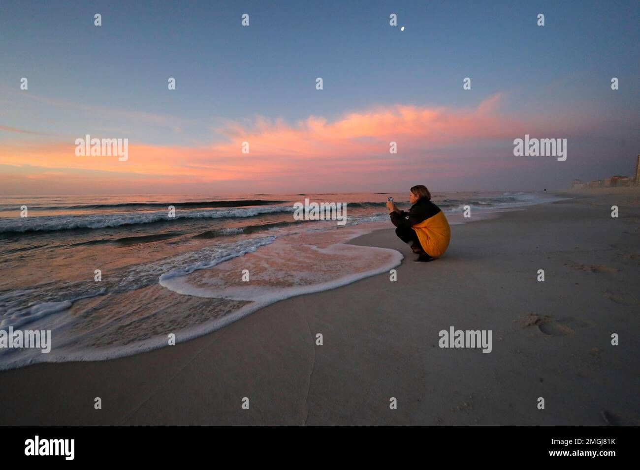 In this March 13, 2020, photo, resident Rachel Bobo takes photos of the ...