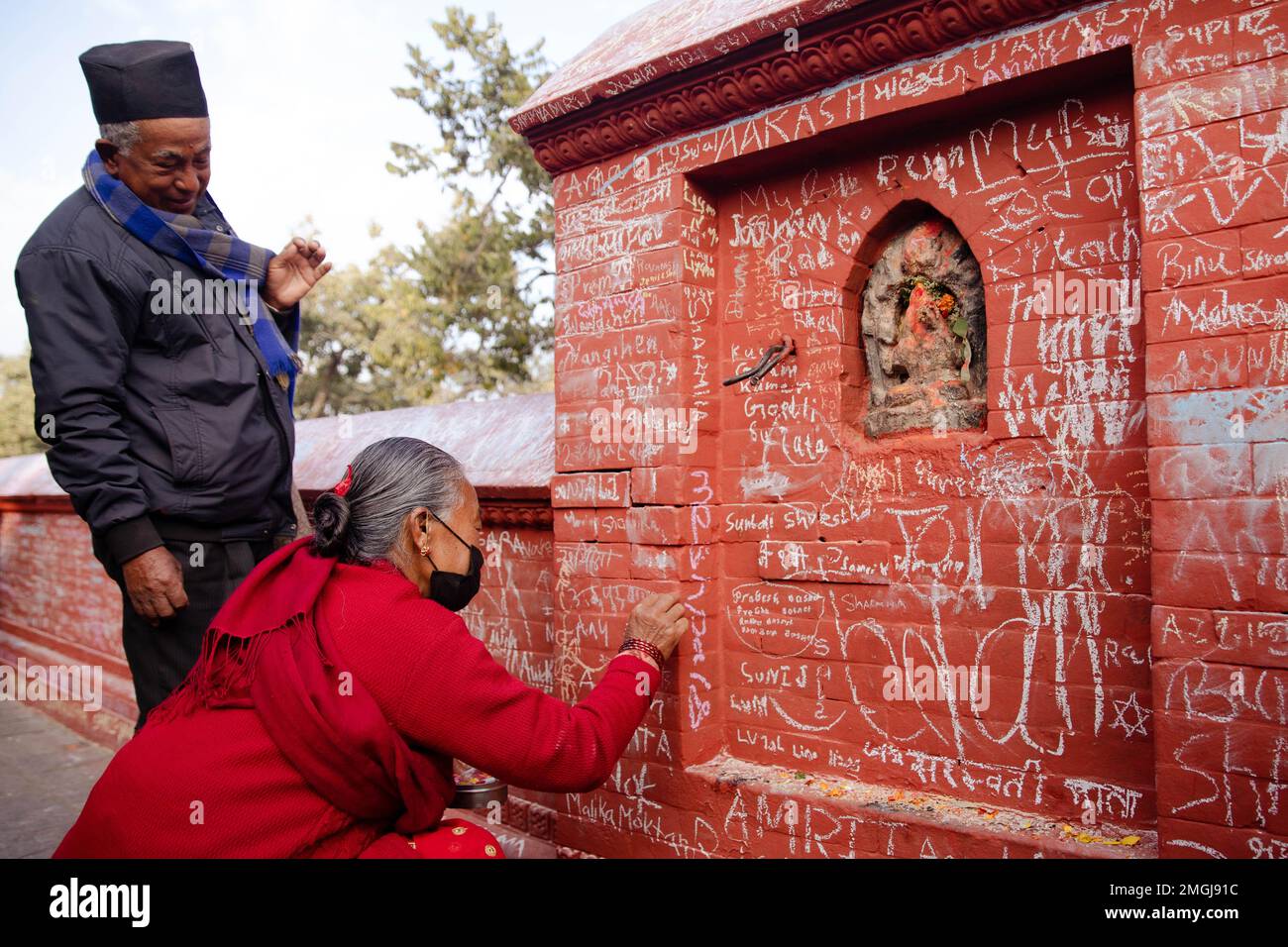 Kathmandu, Nepal. 26th Jan, 2023. An old woman writes on the walls of ...